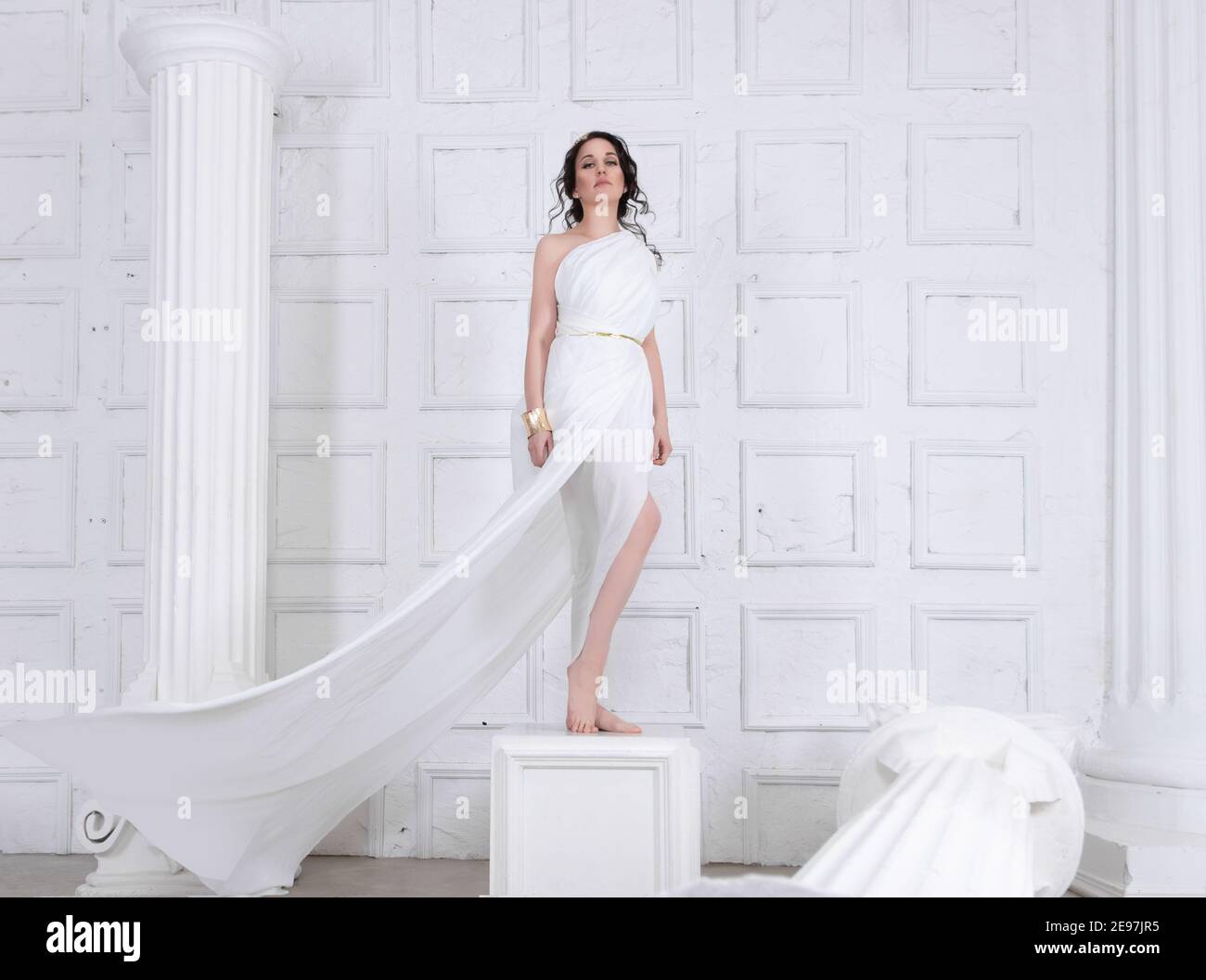 Beautiful Greek goddess woman close up among the white ancient ruins ...