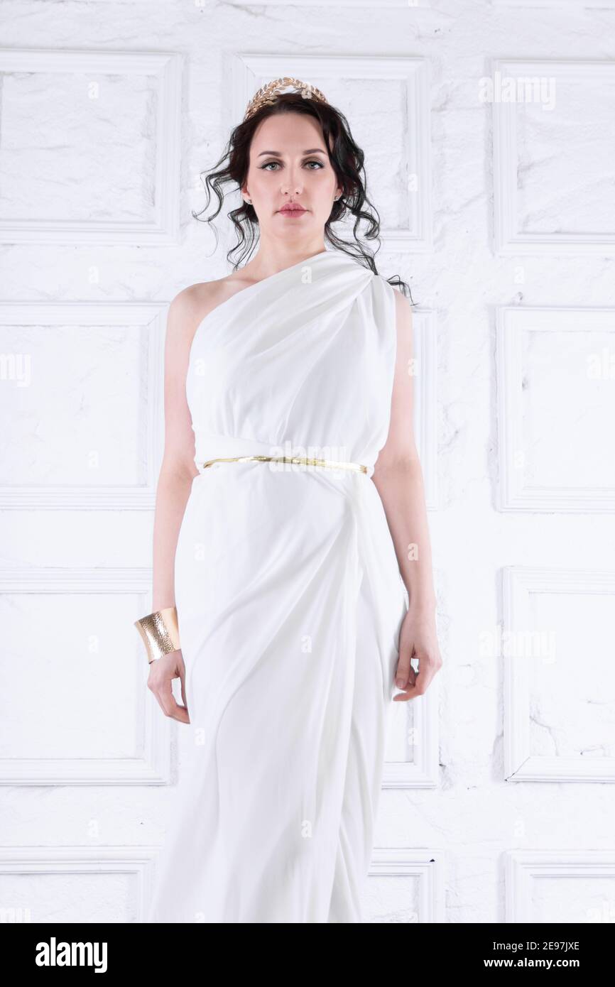 Beautiful Greek goddess woman close up among the white ancient ruins ...