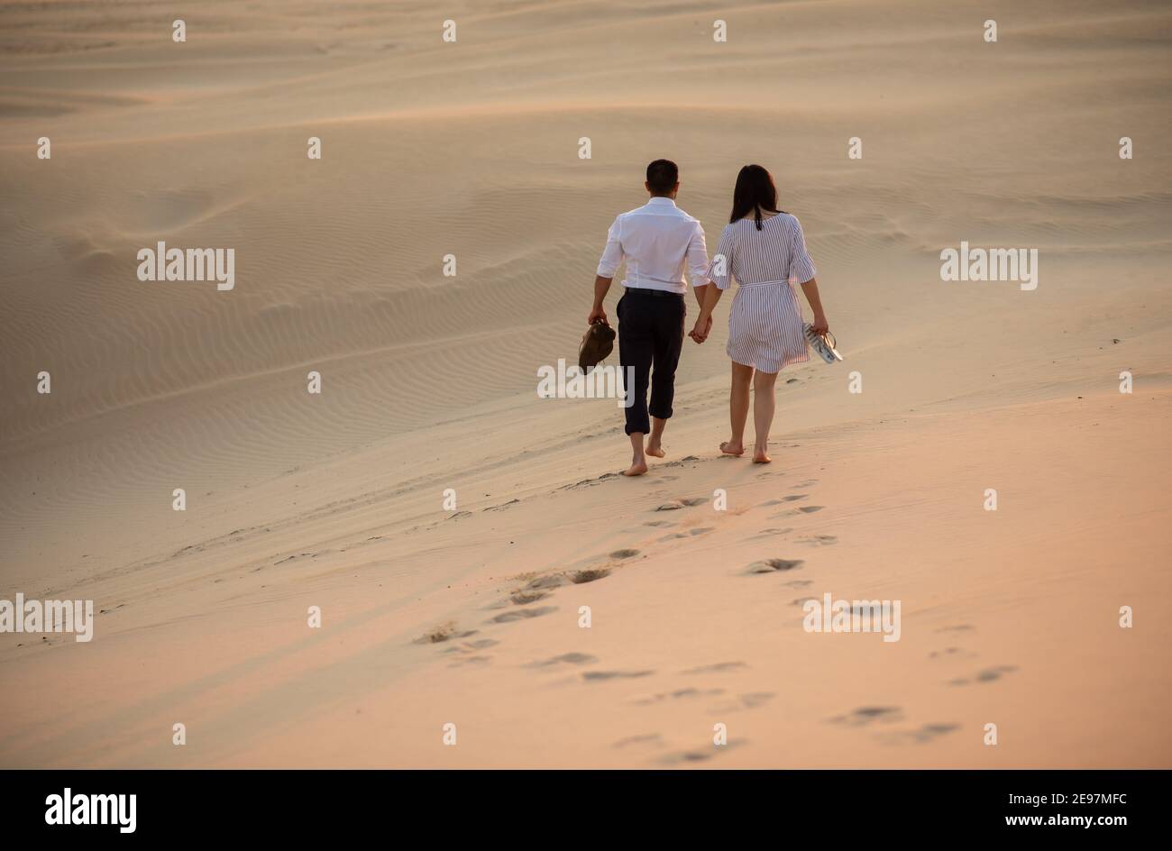 Couple walking on the white sand in a beautiful beach Stock Photo - Alamy