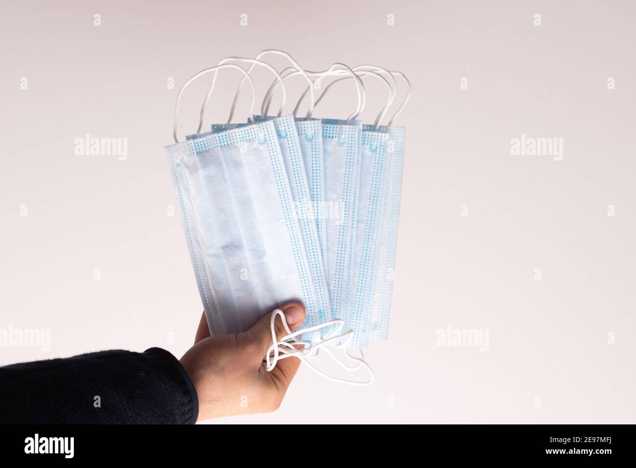 Basic face masks on white background in hand Stock Photo - Alamy