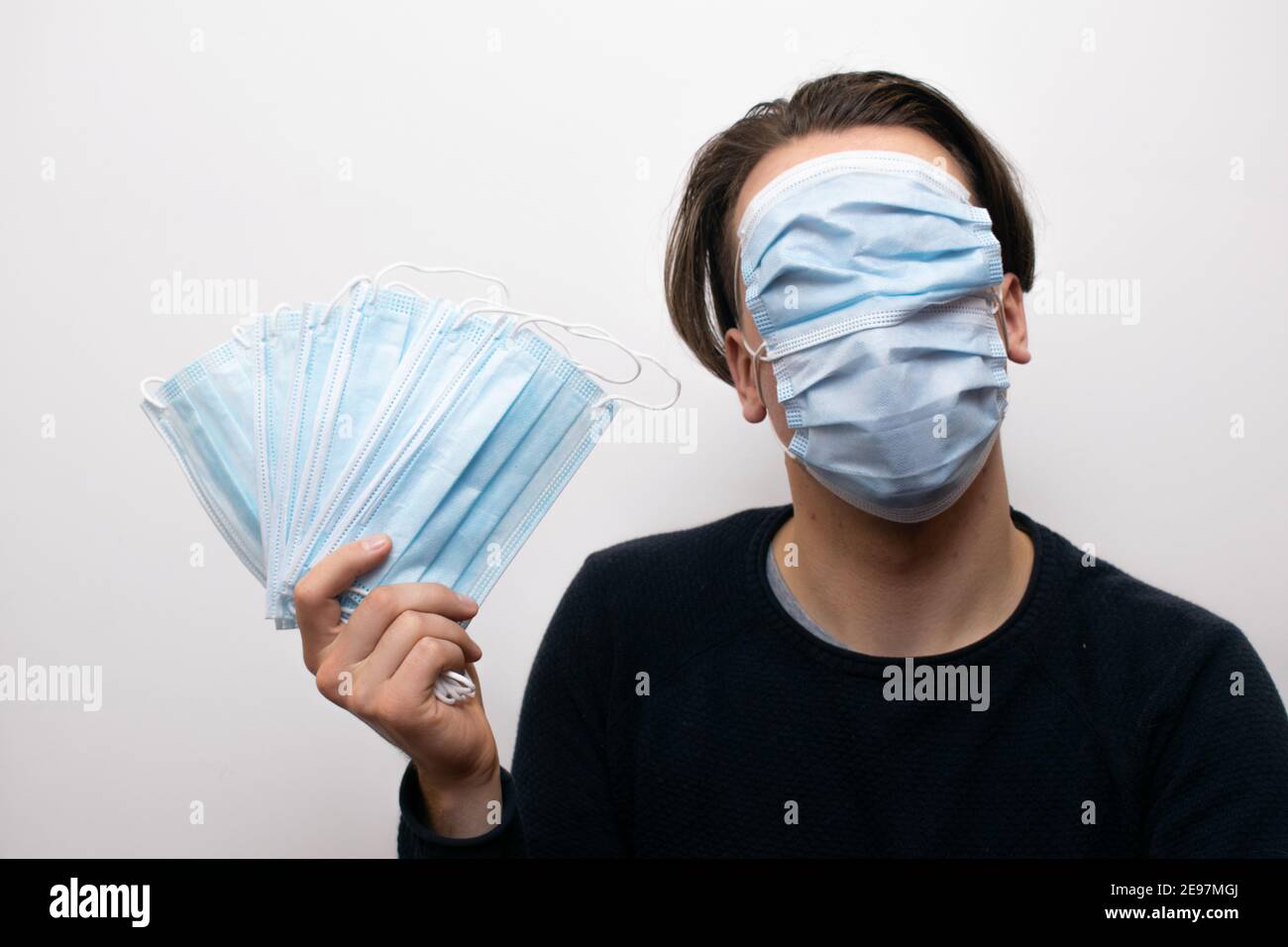 Man getting rich from face masks with two face masks on face Stock ...