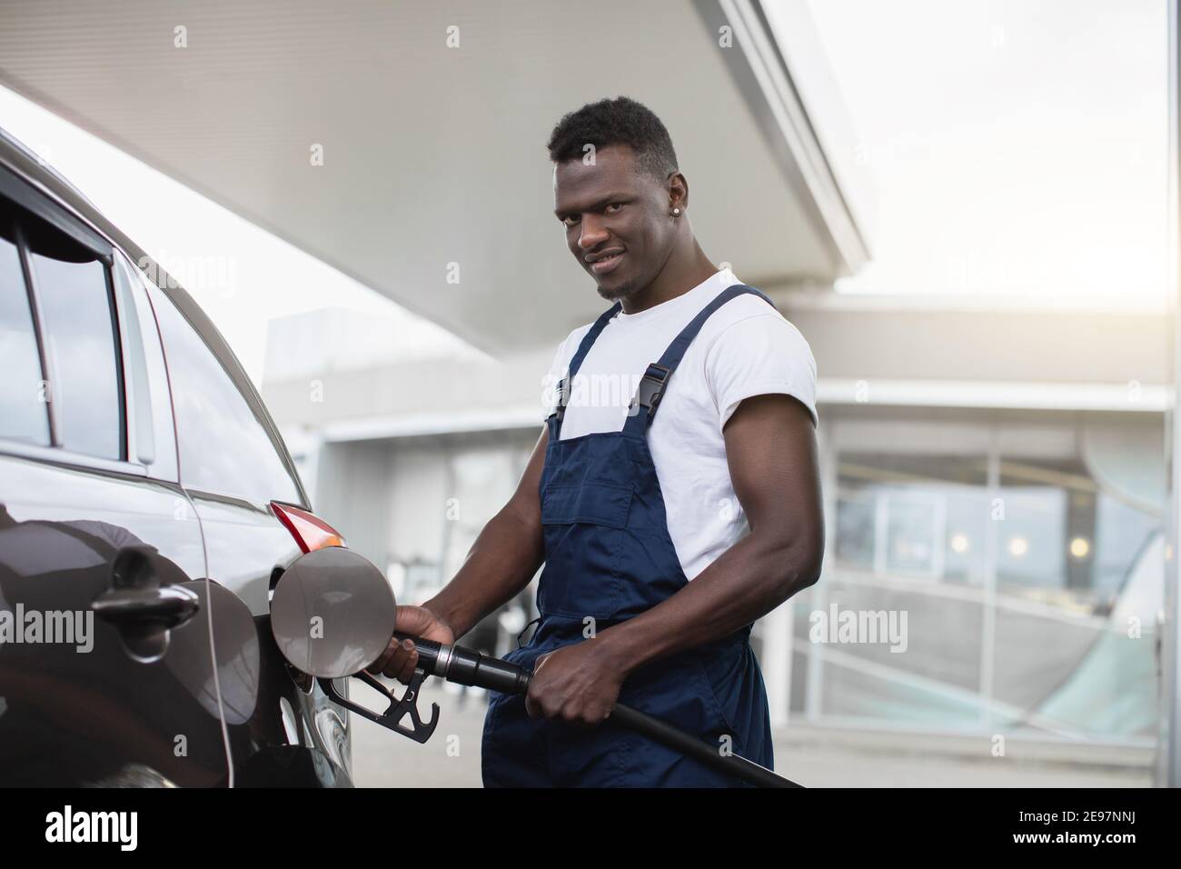 Petrol station, transportation and refueling concept. Handsome young ...