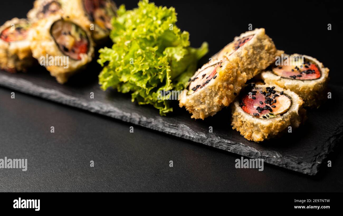 Custom sushi roll in tempura with nori, fresh salmon, tuna, avocado ...