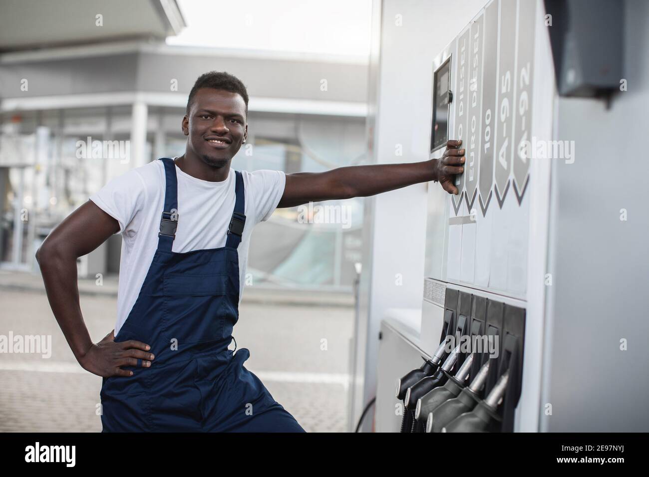 Handsome young smiling black gas station worker on white t-shirt and ...