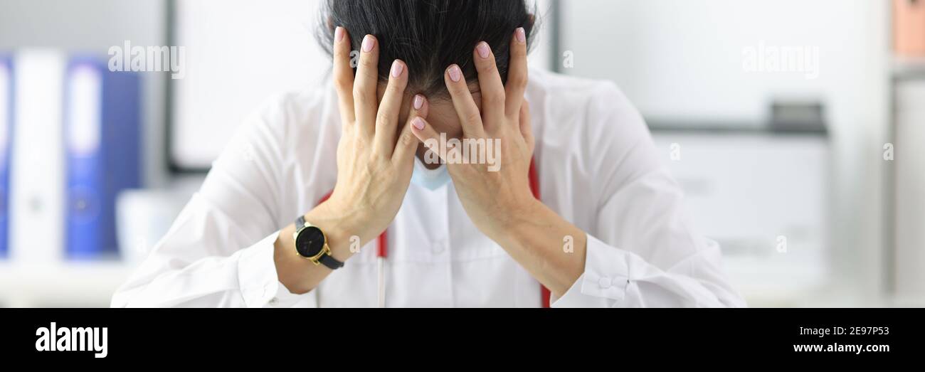 Tired doctor bowing his head in office after working day Stock Photo ...