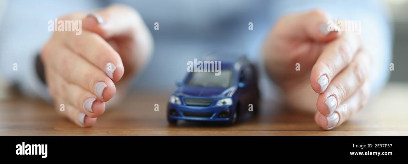 There is car inside the woman's hands Stock Photo - Alamy