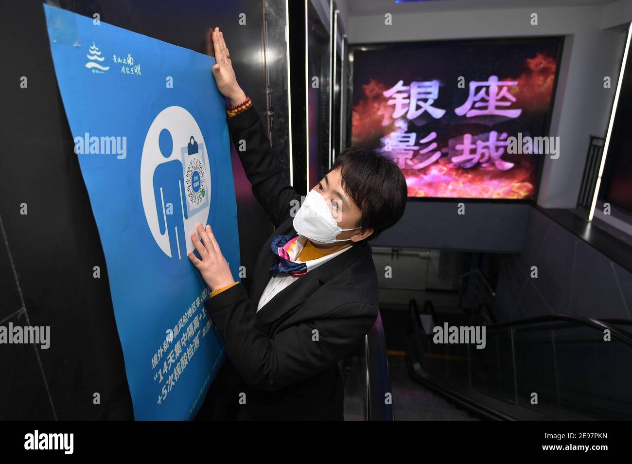 GUIYANG, CHINA - FEBRUARY 3, 2021 - A staff member puts up a poster for ...