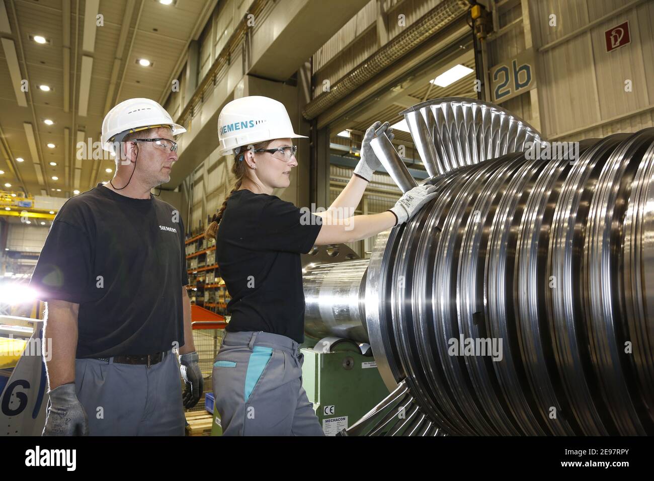 Theme photo, job cuts at Siemens Energy - young engineer in production ...