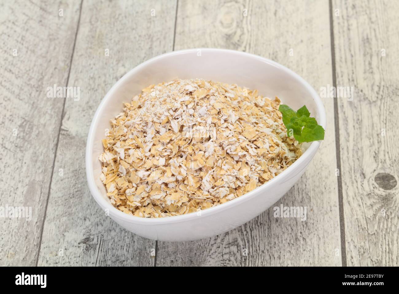 Raw oats in the bowl for breakfast Stock Photo - Alamy