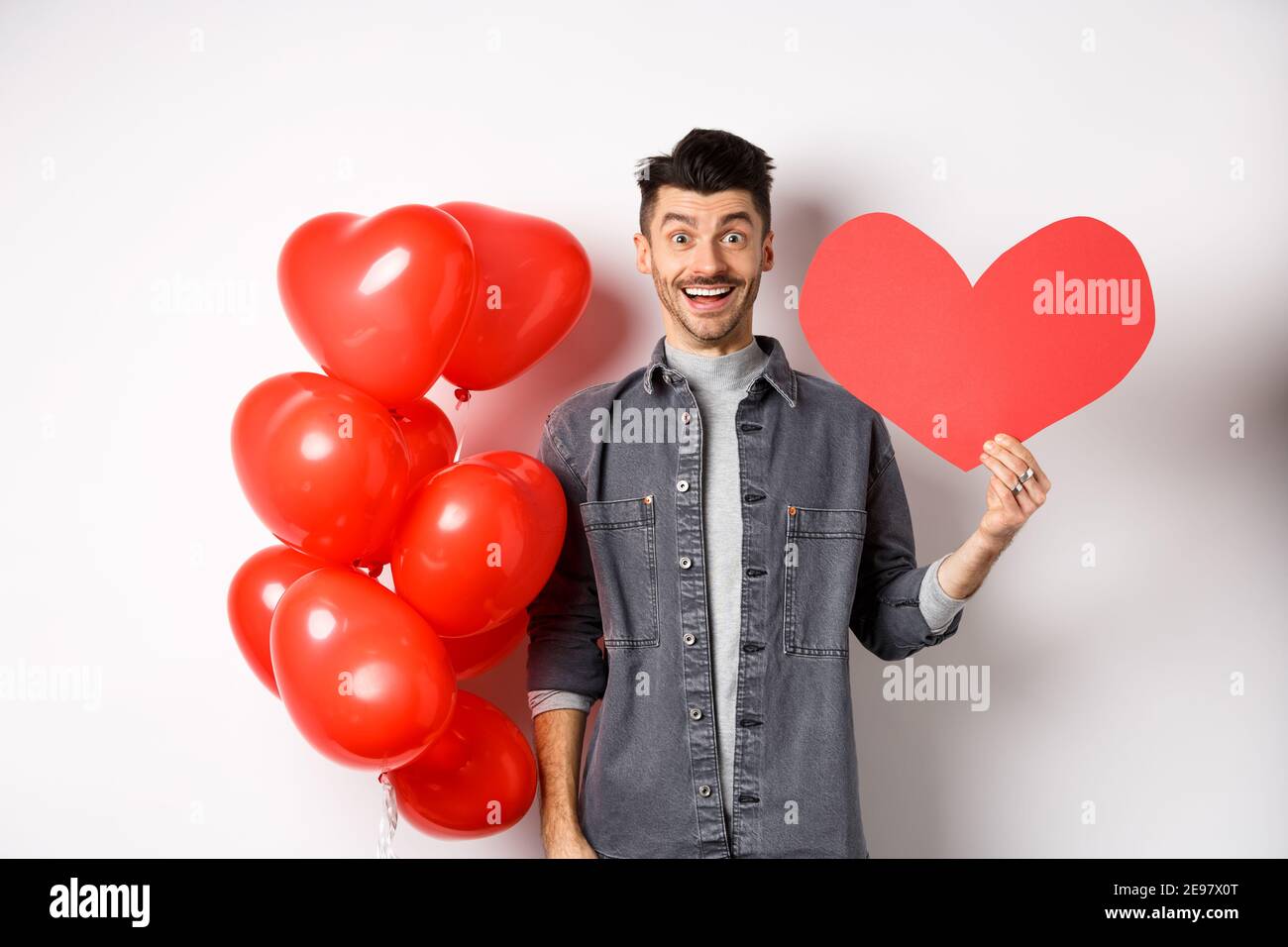 Valentines day and love concept. Cheerful funny guy showing heart ...