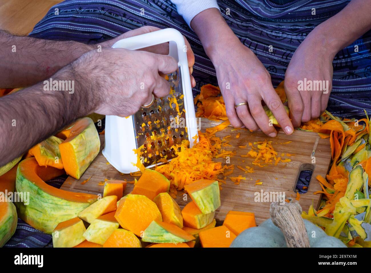 Making the sweet pumpkin pastry. Woman cutting and slicing a pumpkin on ...