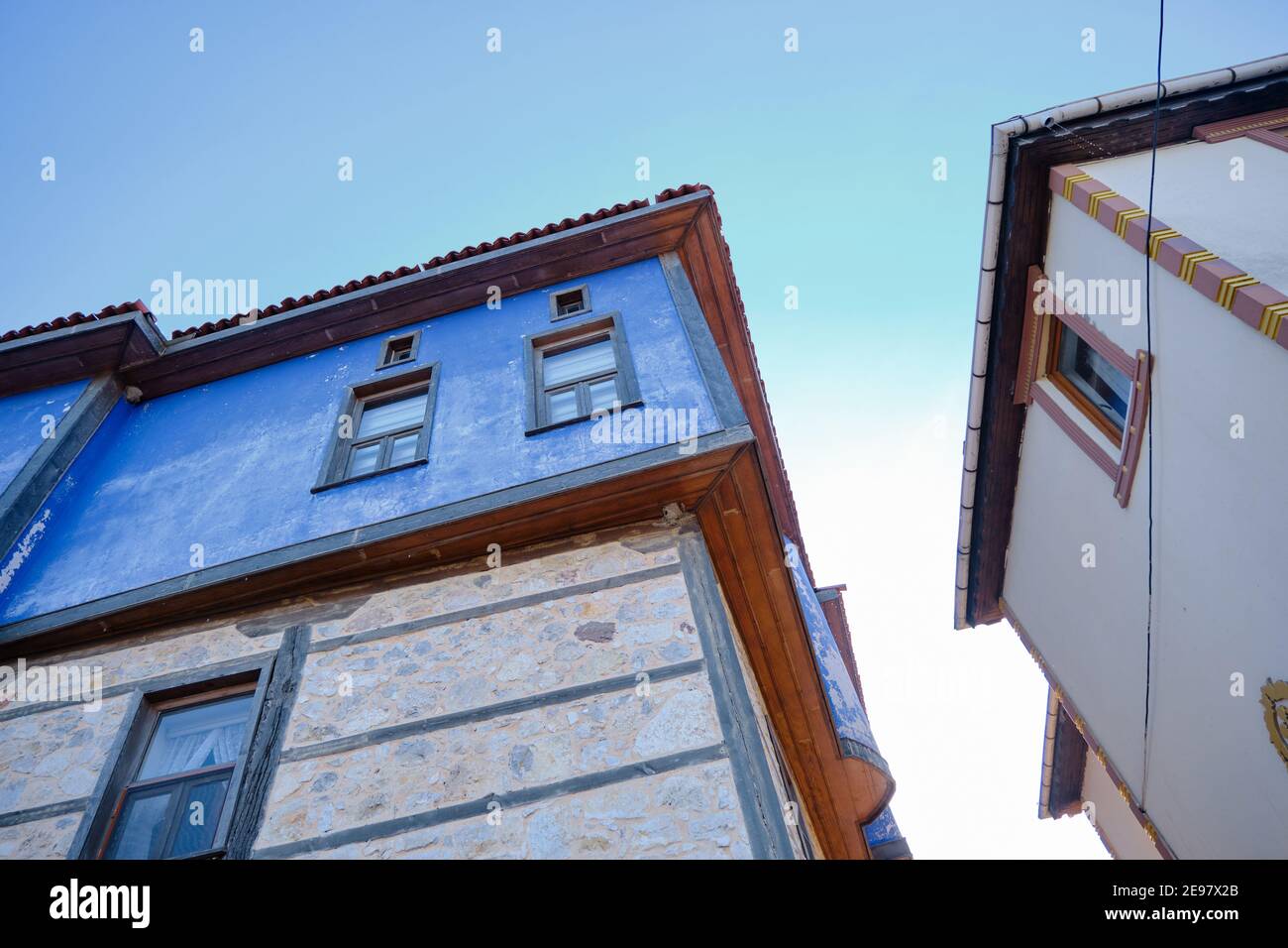 Old ottoman style house with blue color and narrow street with sunshine ...