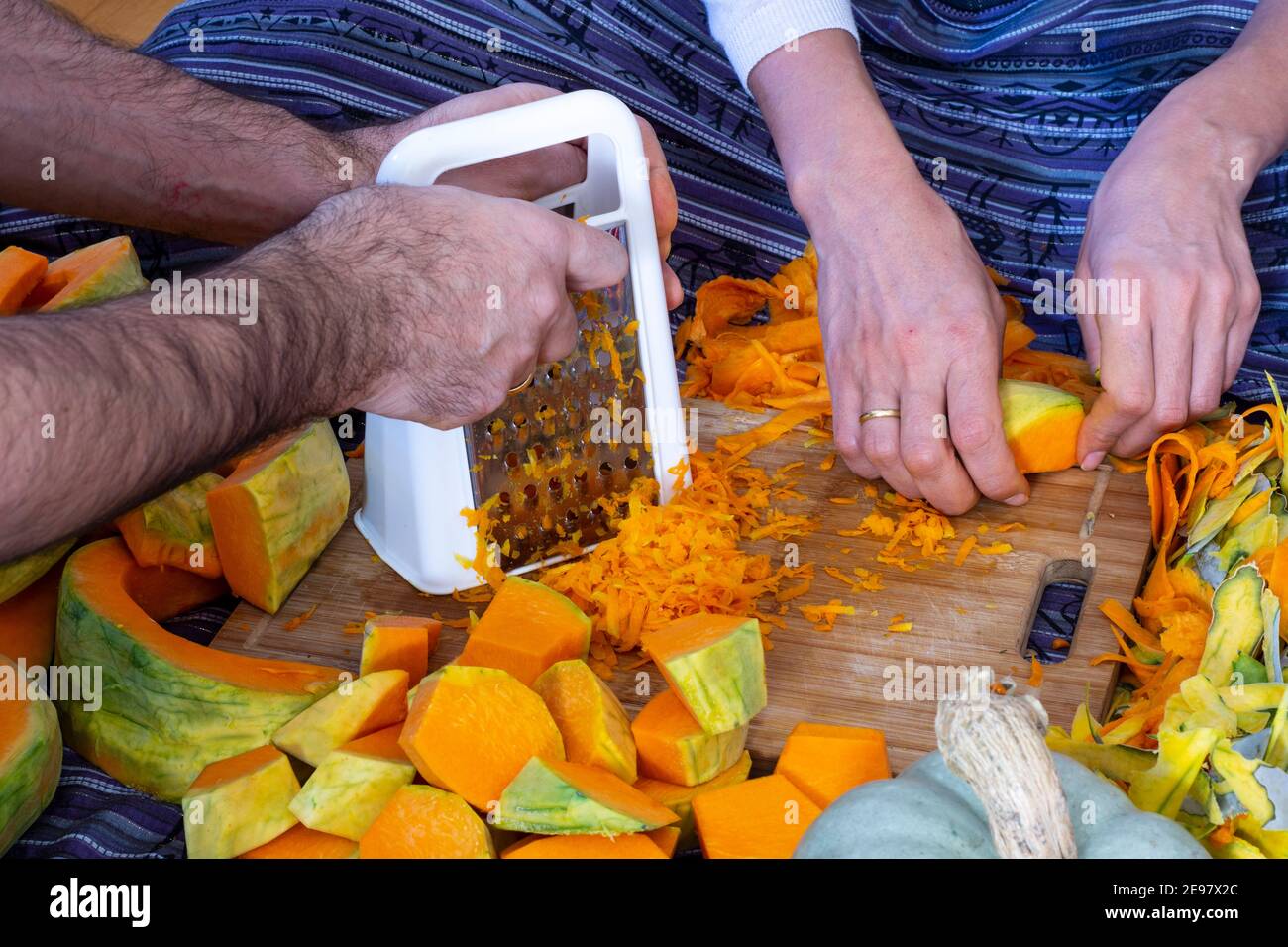 Making the sweet pumpkin pastry. Woman cutting and slicing a pumpkin on ...