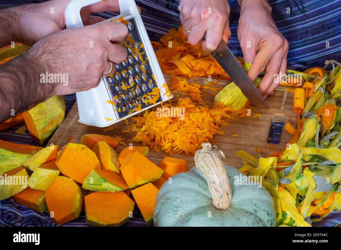 Making the sweet pumpkin pastry. Woman cutting and slicing a pumpkin on ...
