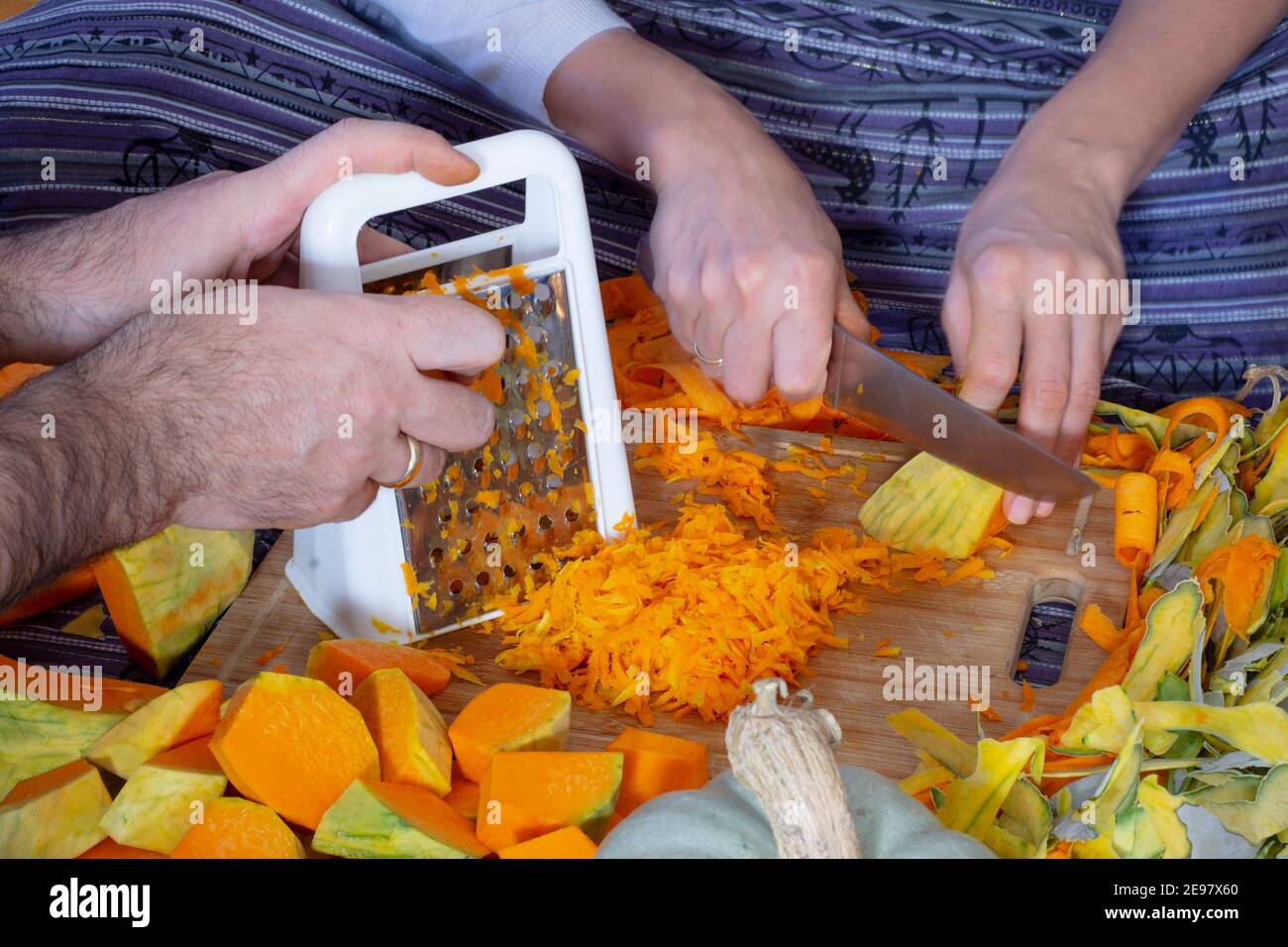 Making the sweet pumpkin pastry. Woman cutting and slicing a pumpkin on ...