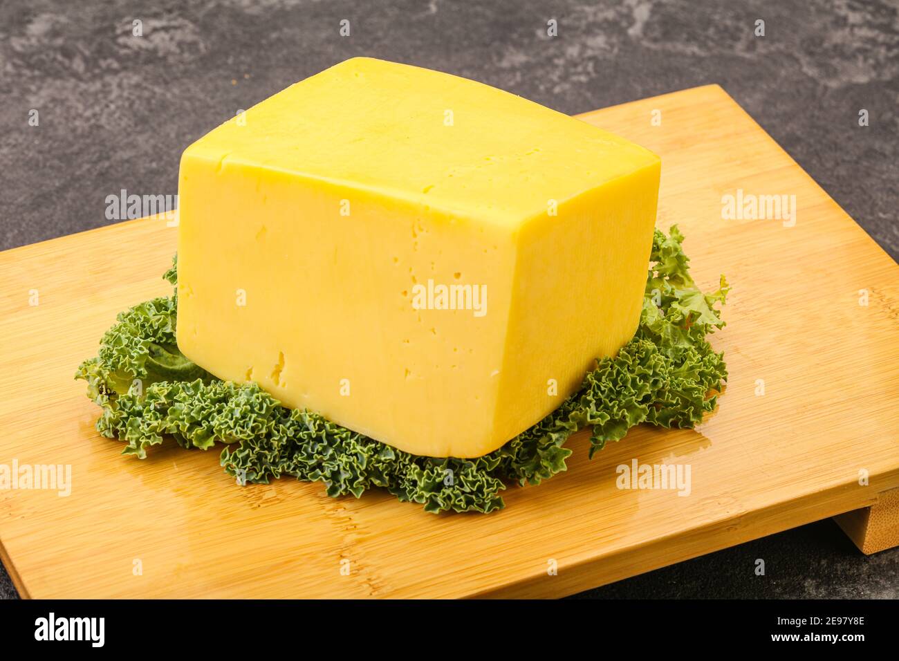 Yellow tilsiter cheese dairy product brick Stock Photo - Alamy