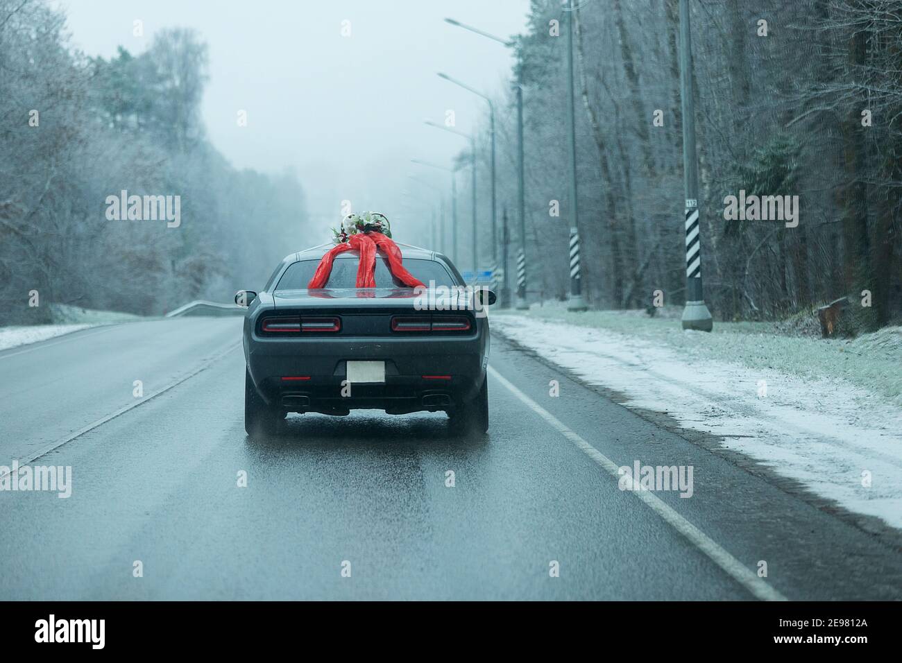 the car is driving on a winter snow-covered highway, bad weather ...