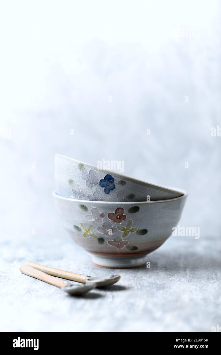 Traditional ceramic bowls on bright background Stock Photo - Alamy