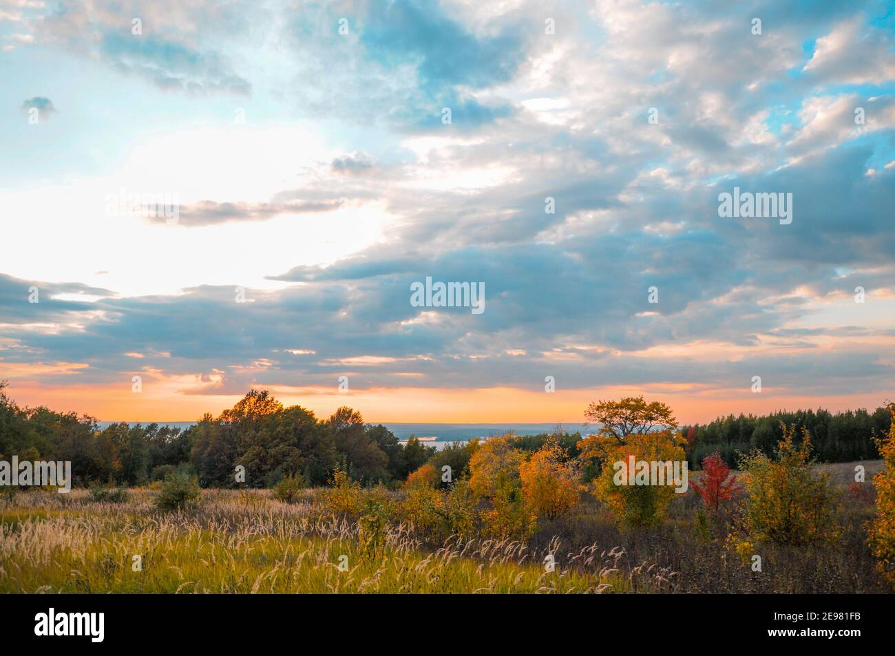 Colorful autumn landscape at sunset, view of the sunlit hills, the ...