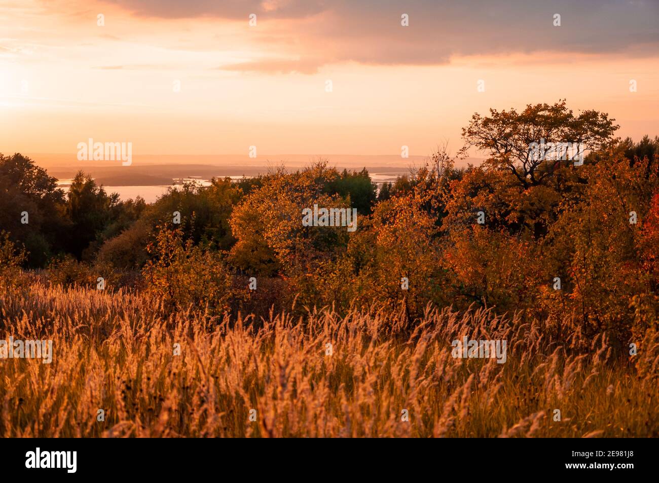 Colorful autumn landscape at sunset, view of the sunlit hills, the ...