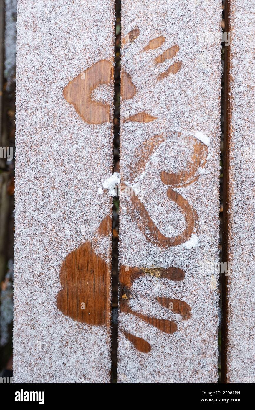 two lovers draw with their fingers in the snow, draw hearts in the snow ...