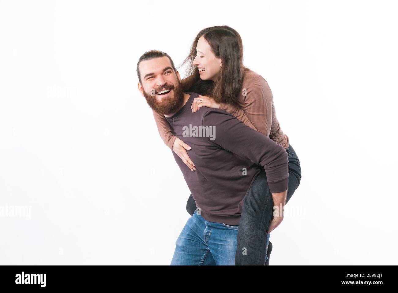Photo of happy young couple having fun and embracing over white ...