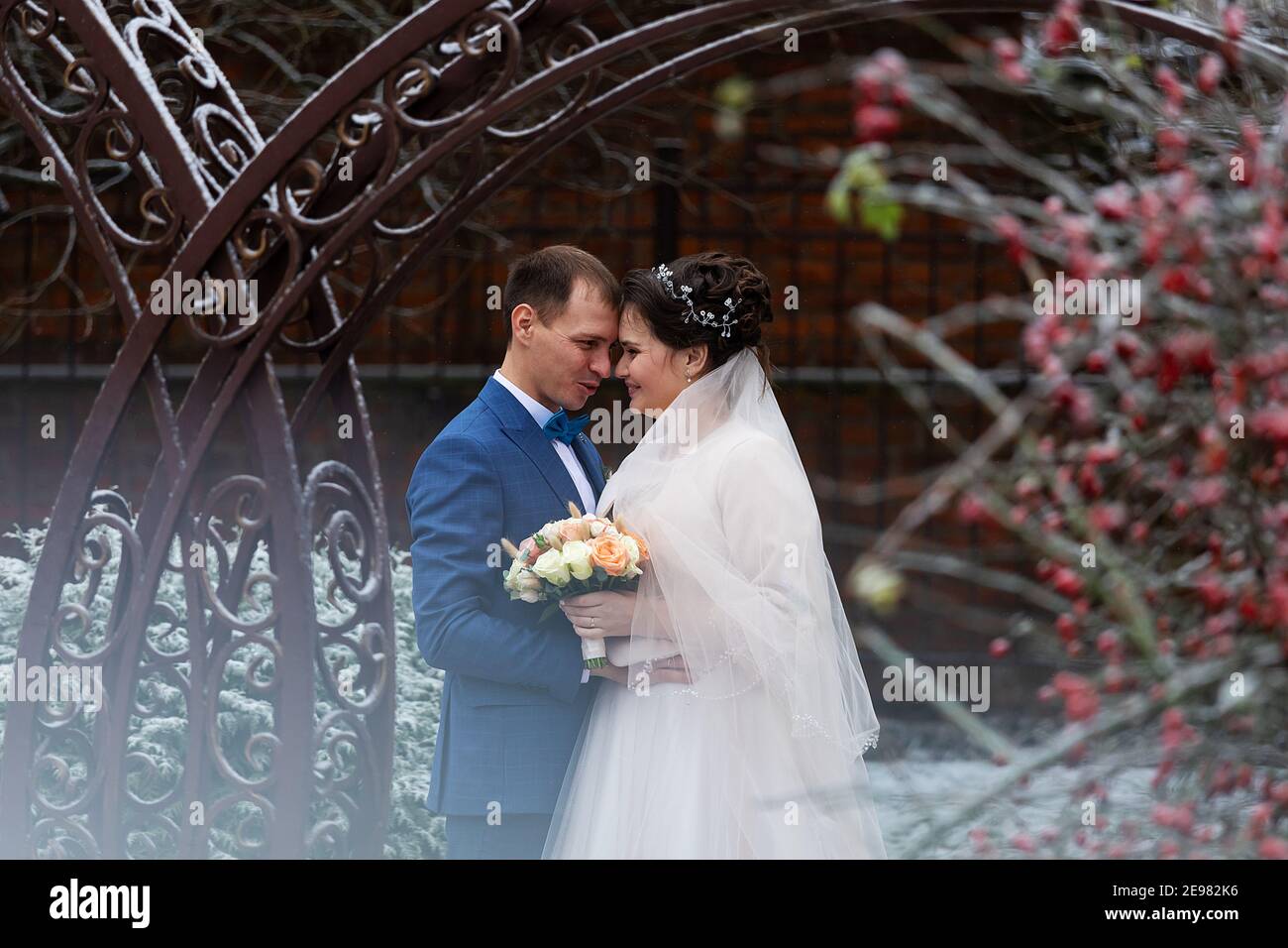 the bride and groom on the background of a church, religious lovers, a ...