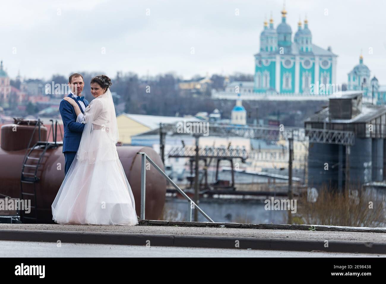 the bride and groom on the background of a church, religious lovers, a ...