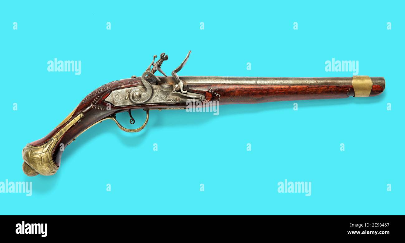 Side view of a single barrel antique wooden flintlock pistol with ...