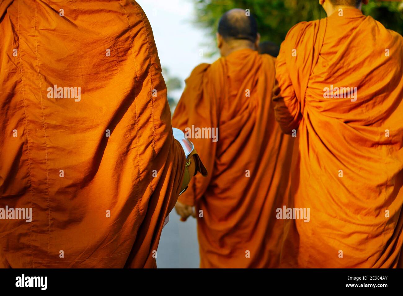 monks dressing orange robe during reception of alms, around buddhist ...