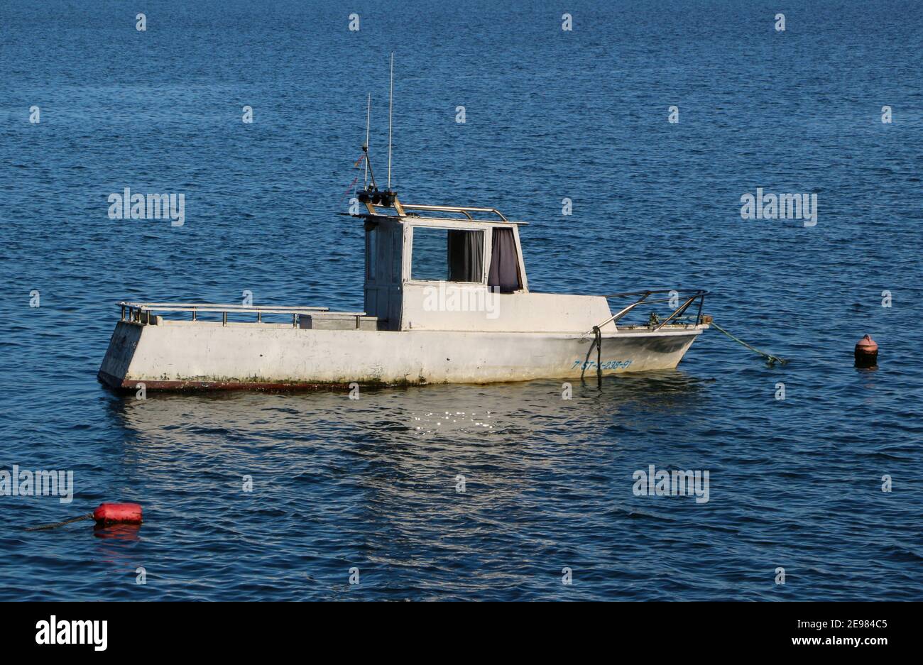 Sad looking small moored fishing boat still floating but nose down in ...