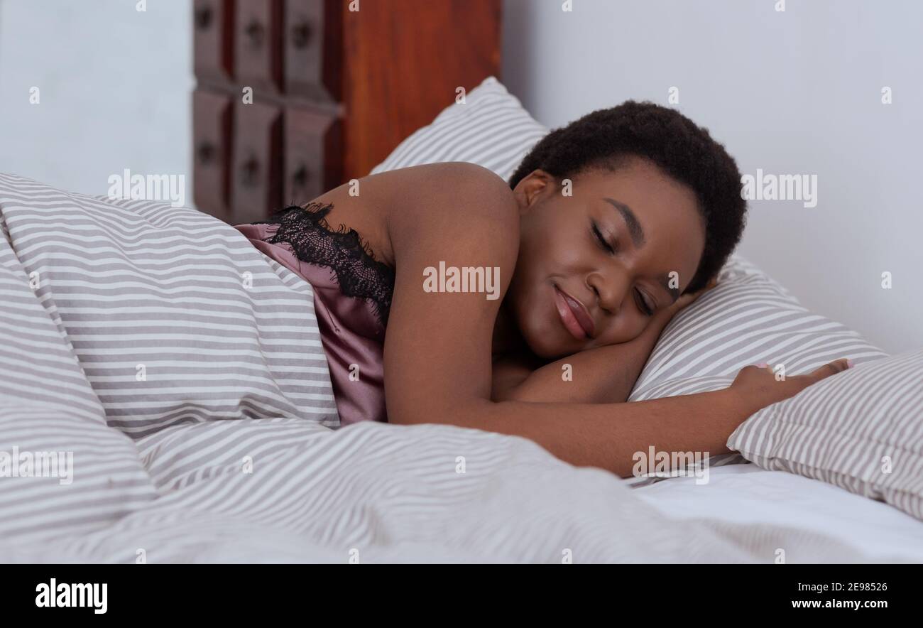 African woman sleeping on bed hi-res stock photography and images - Alamy