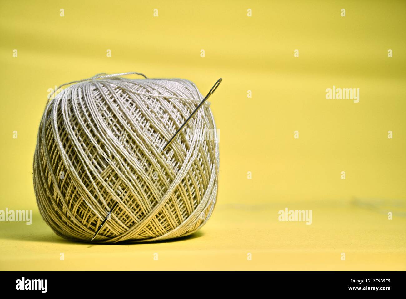 Needle and yellow thread with black background Close up Needle and ...