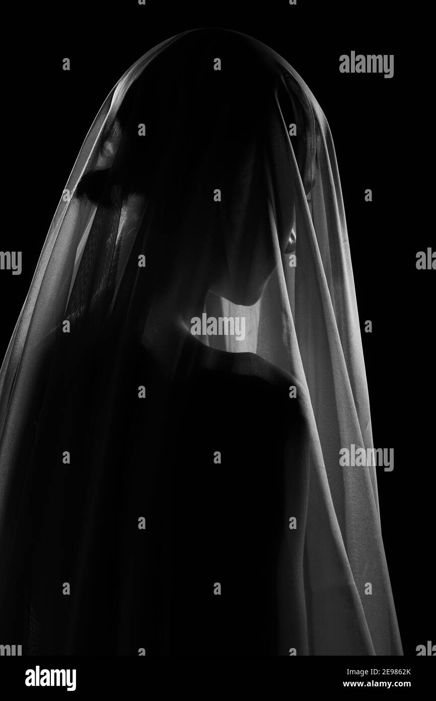 woman under veil posing sensually on black background, profile side ...