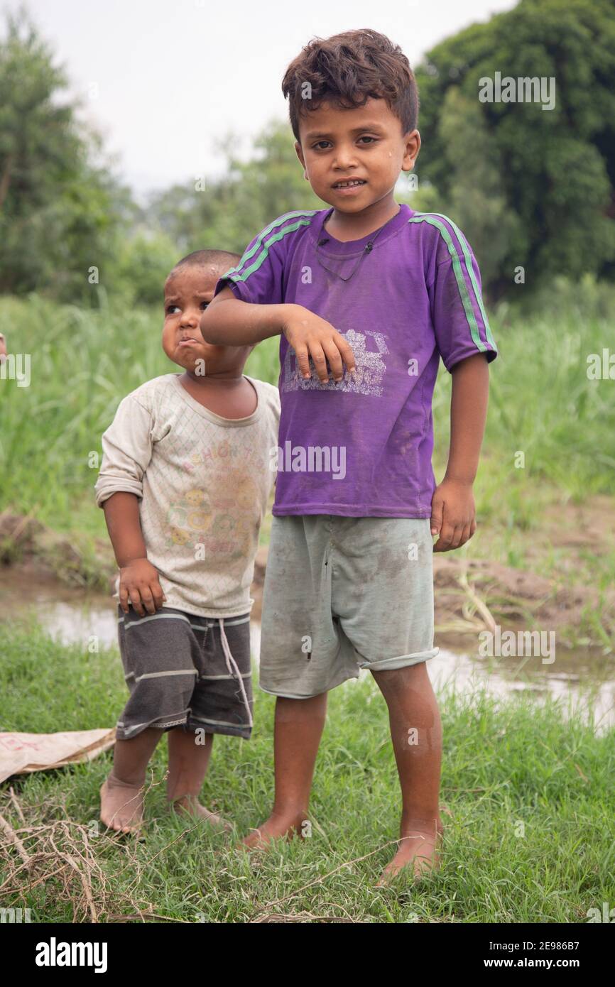 Portrait of two poor Indian children standing Stock Photo - Alamy