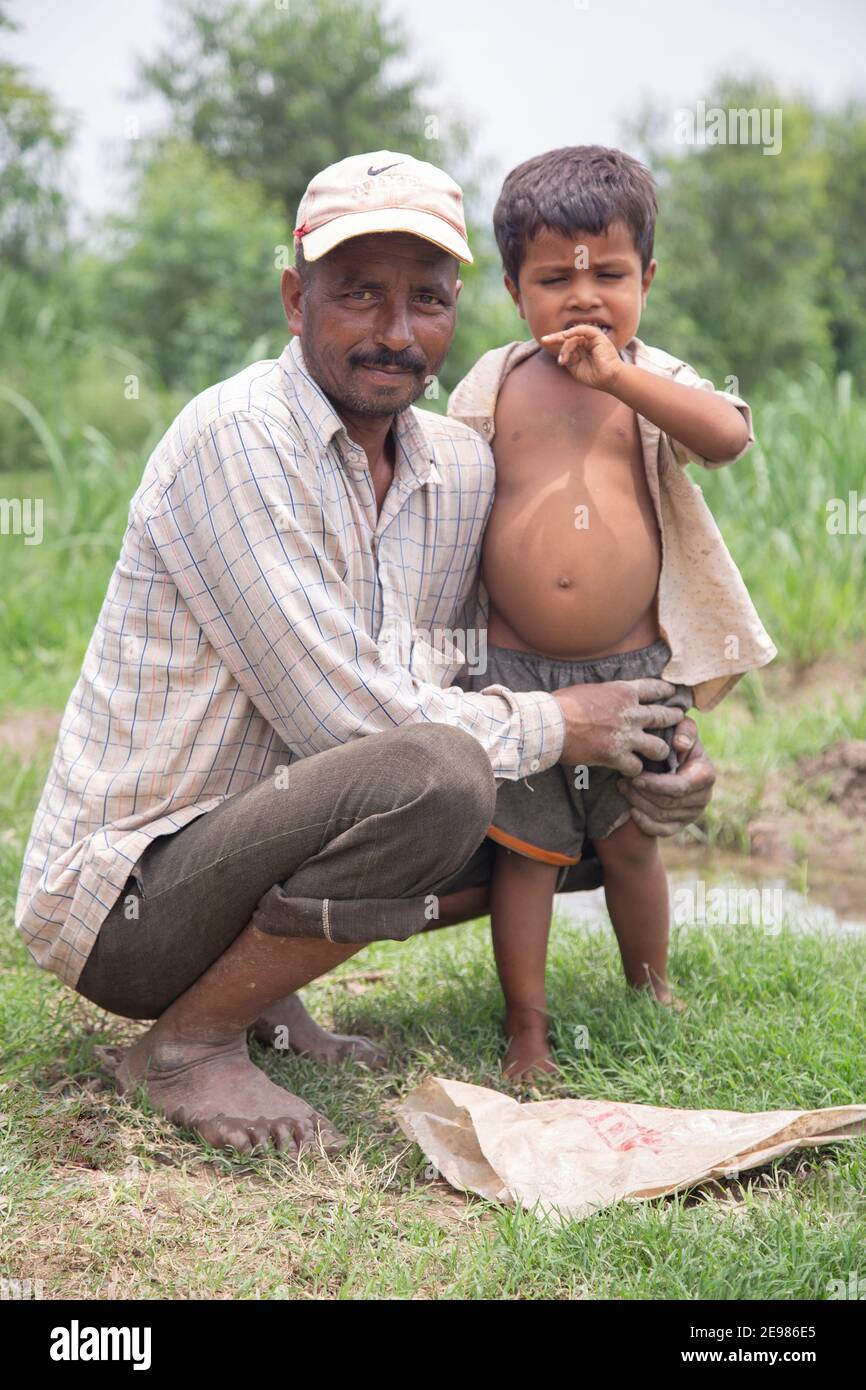 Real people from rural India: Happy father and son. Indian farmer with ...
