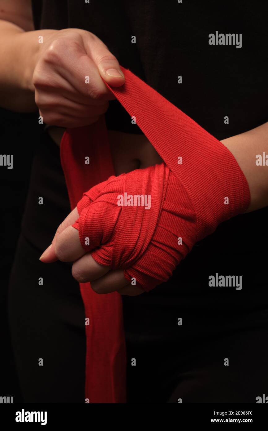 Muay Thai female boxer wearing strap on wrist closeup view. Fitness ...