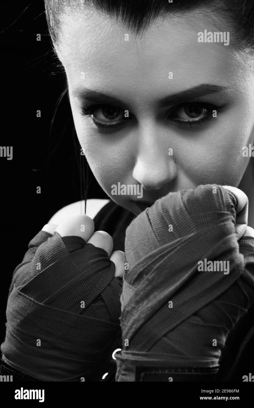 Muay Thai female boxer in attack pose. Fitness young woman boxing ...