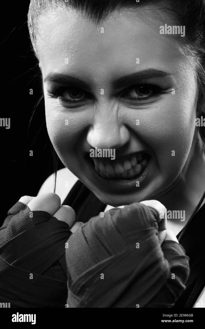 Angry Muay Thai female boxer in attack pose. Fitness young woman boxing ...