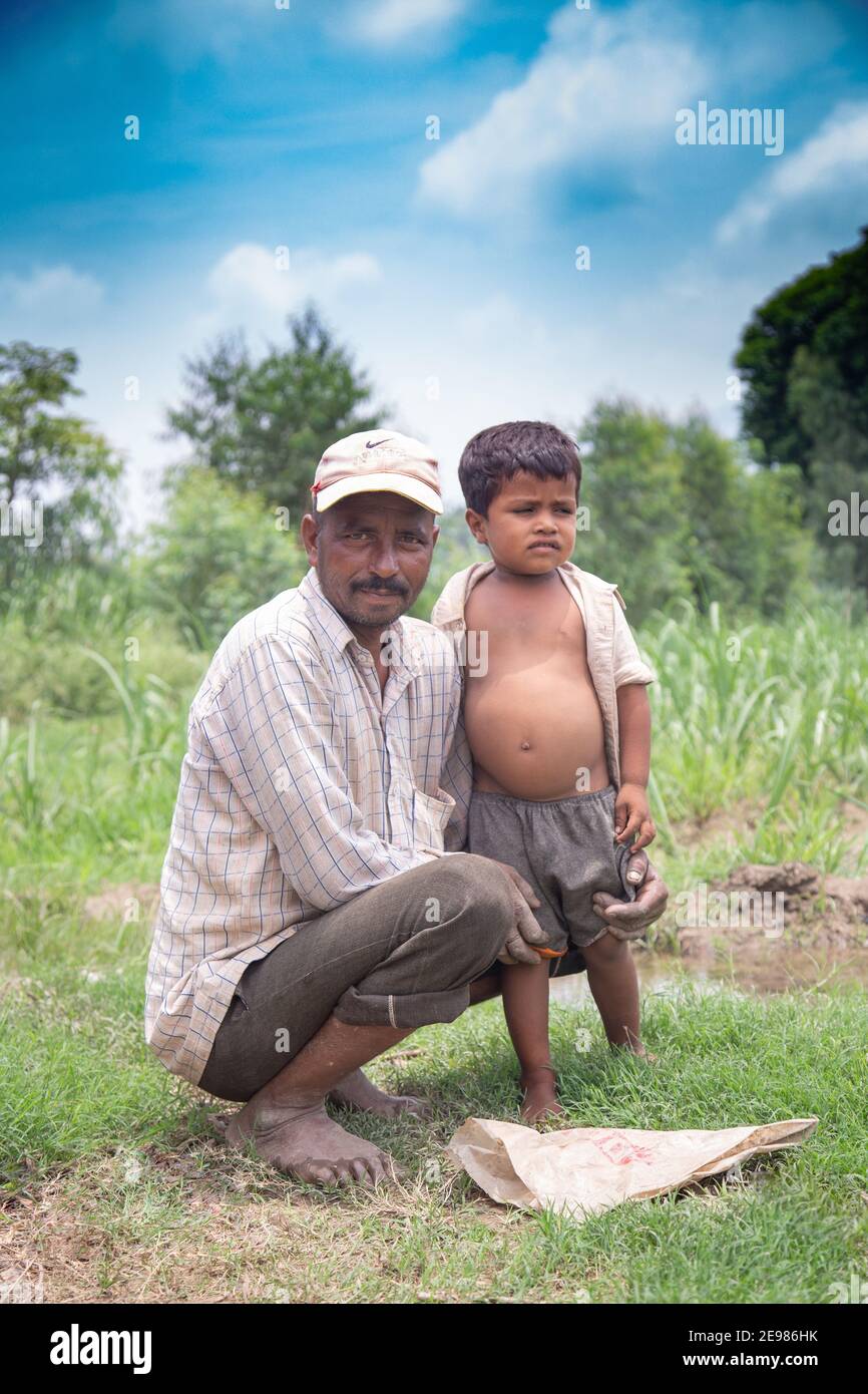 Real people from rural India: Happy father and son. Indian farmer with ...