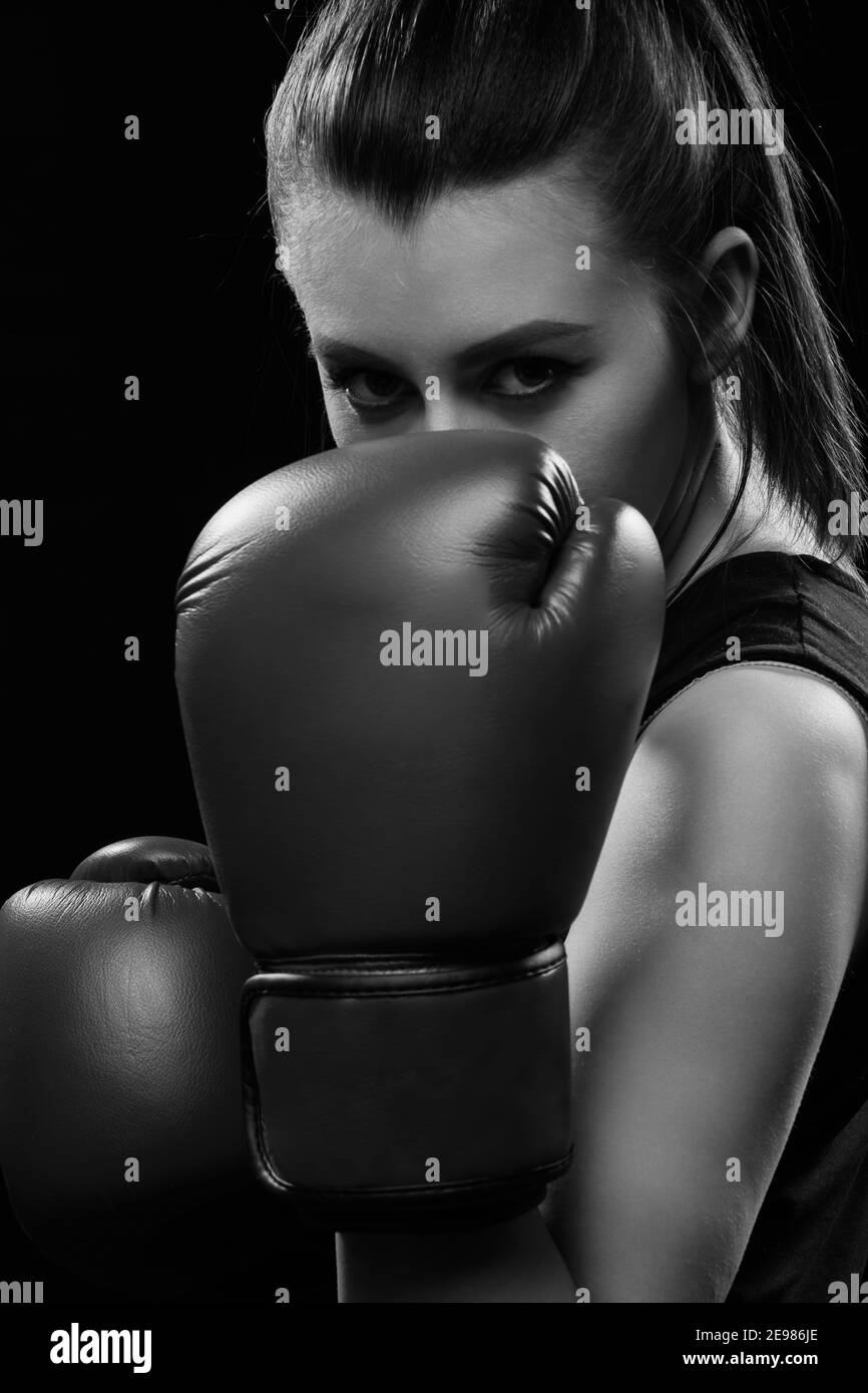 Angry Muay Thai female boxer in attack pose. Fitness young woman boxing ...