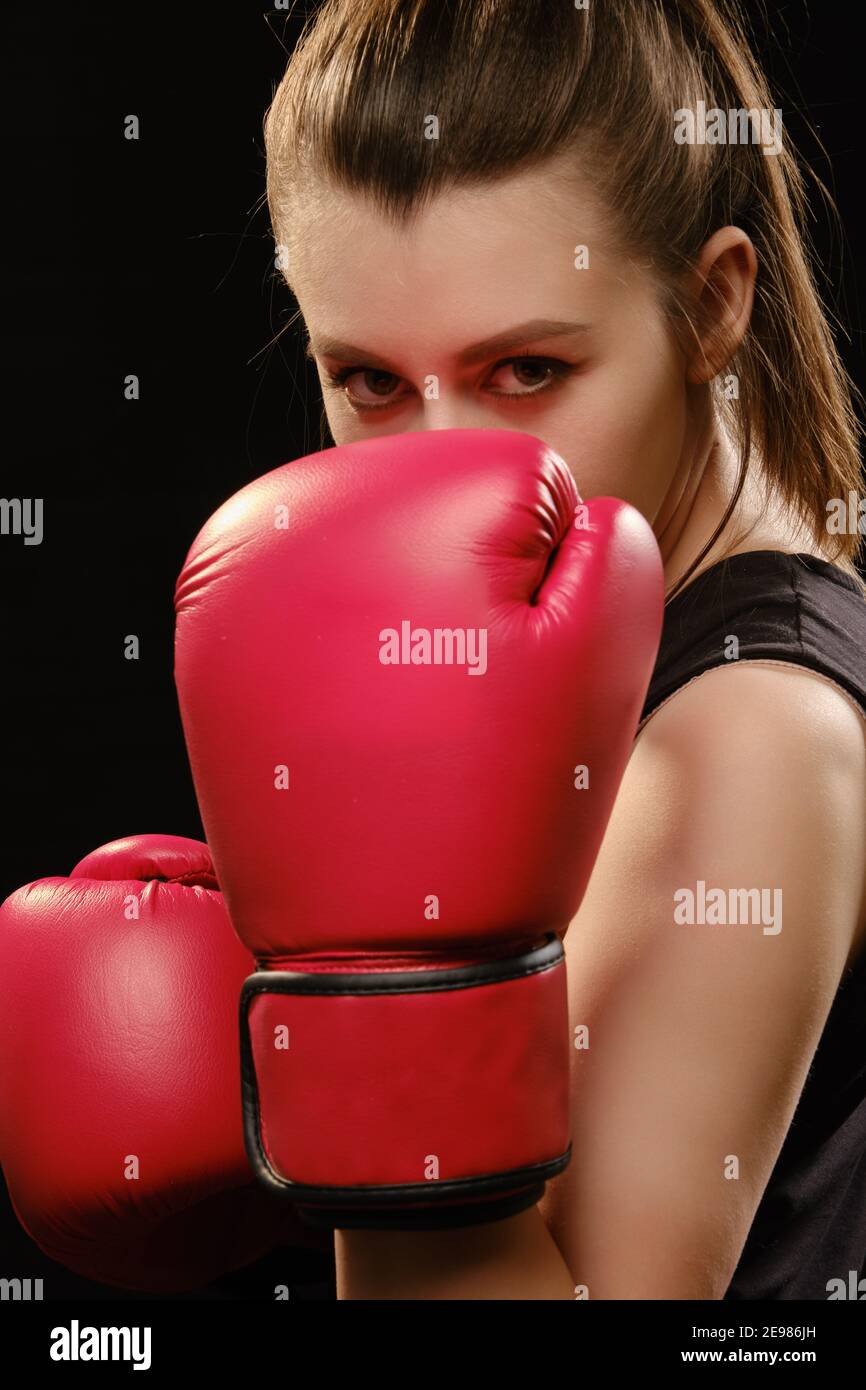 Angry Muay Thai female boxer in attack pose. Fitness young woman boxing ...