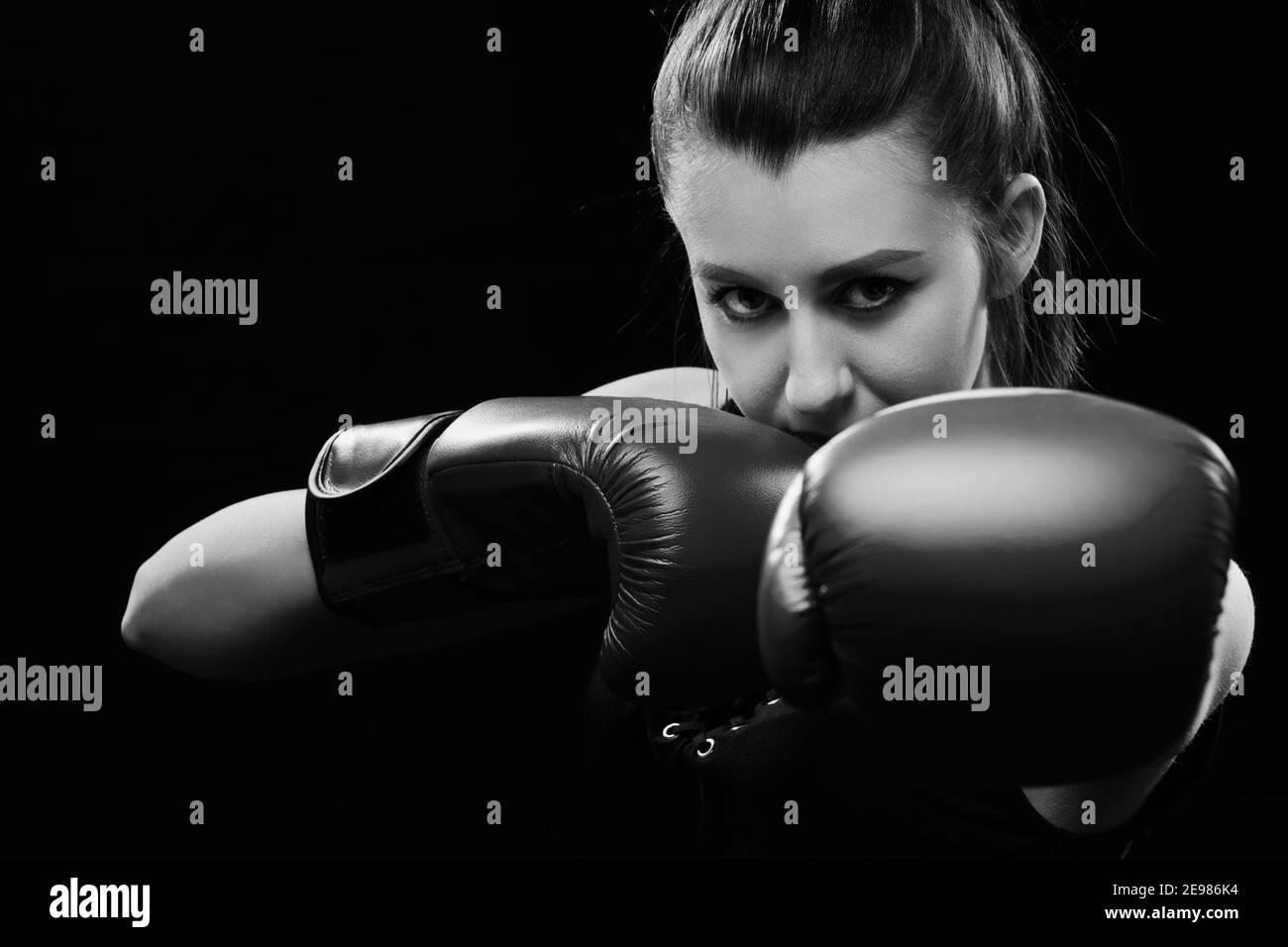 Angry Muay Thai female boxer in attack pose. Fitness young woman boxing ...