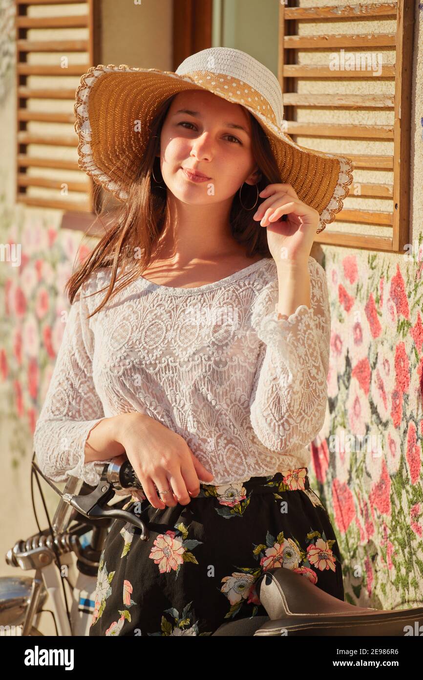 pretty girl in sun hat in sun light looking at camera, smiling Stock ...