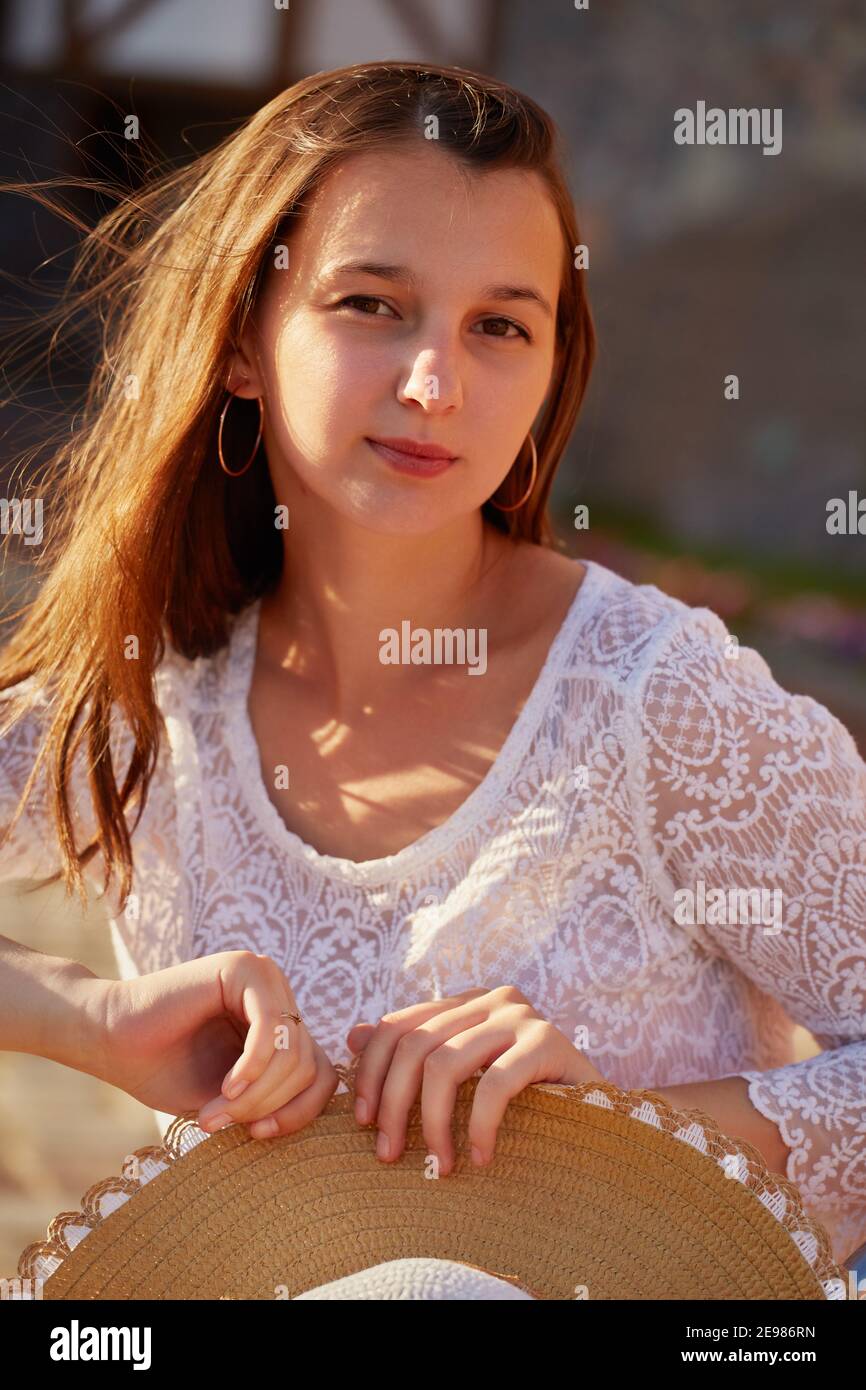 pretty girl with sun hat in sun light looking at camera, smiling Stock ...