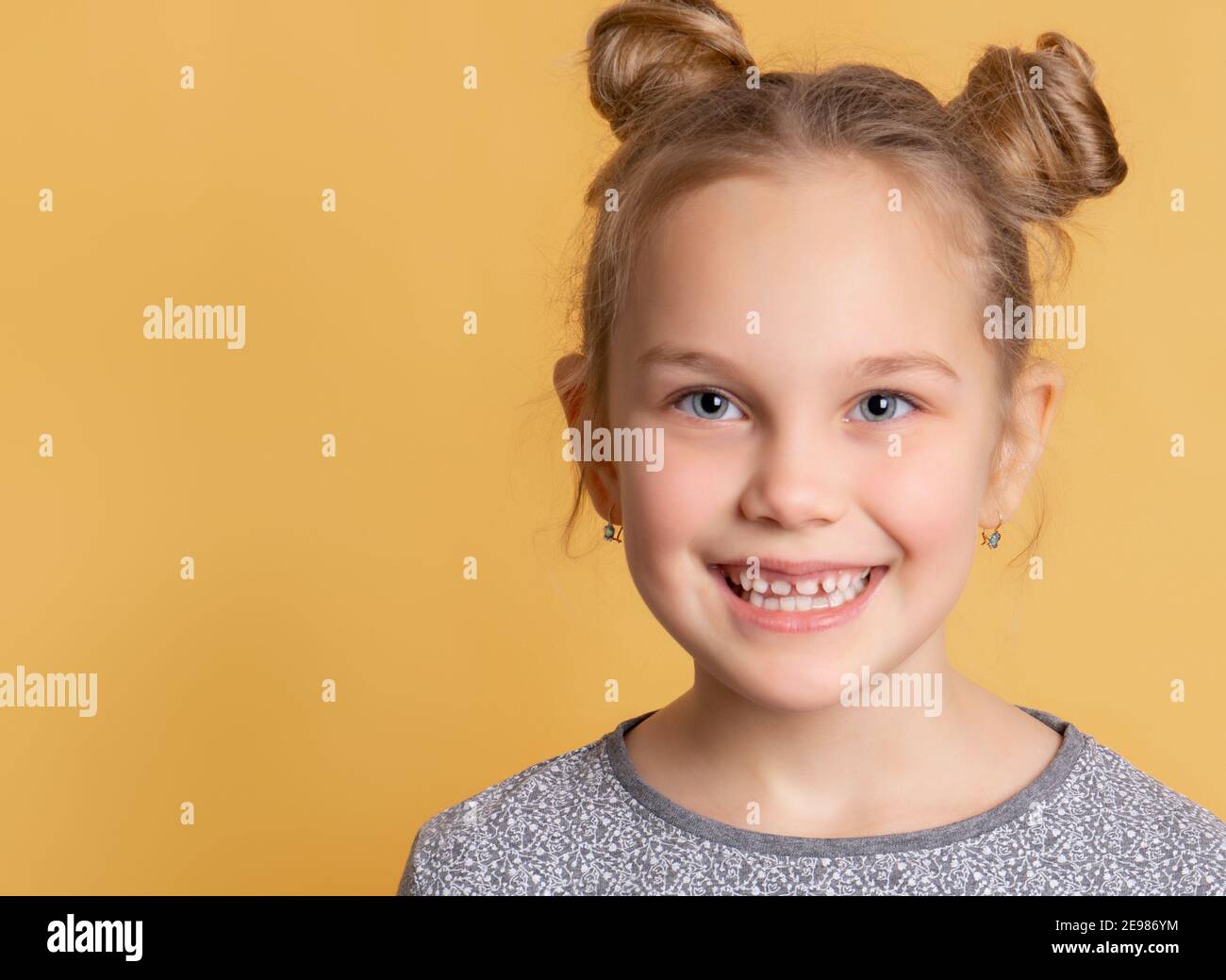 Child shows his healthy teeth. Close up of the face of a little cute ...