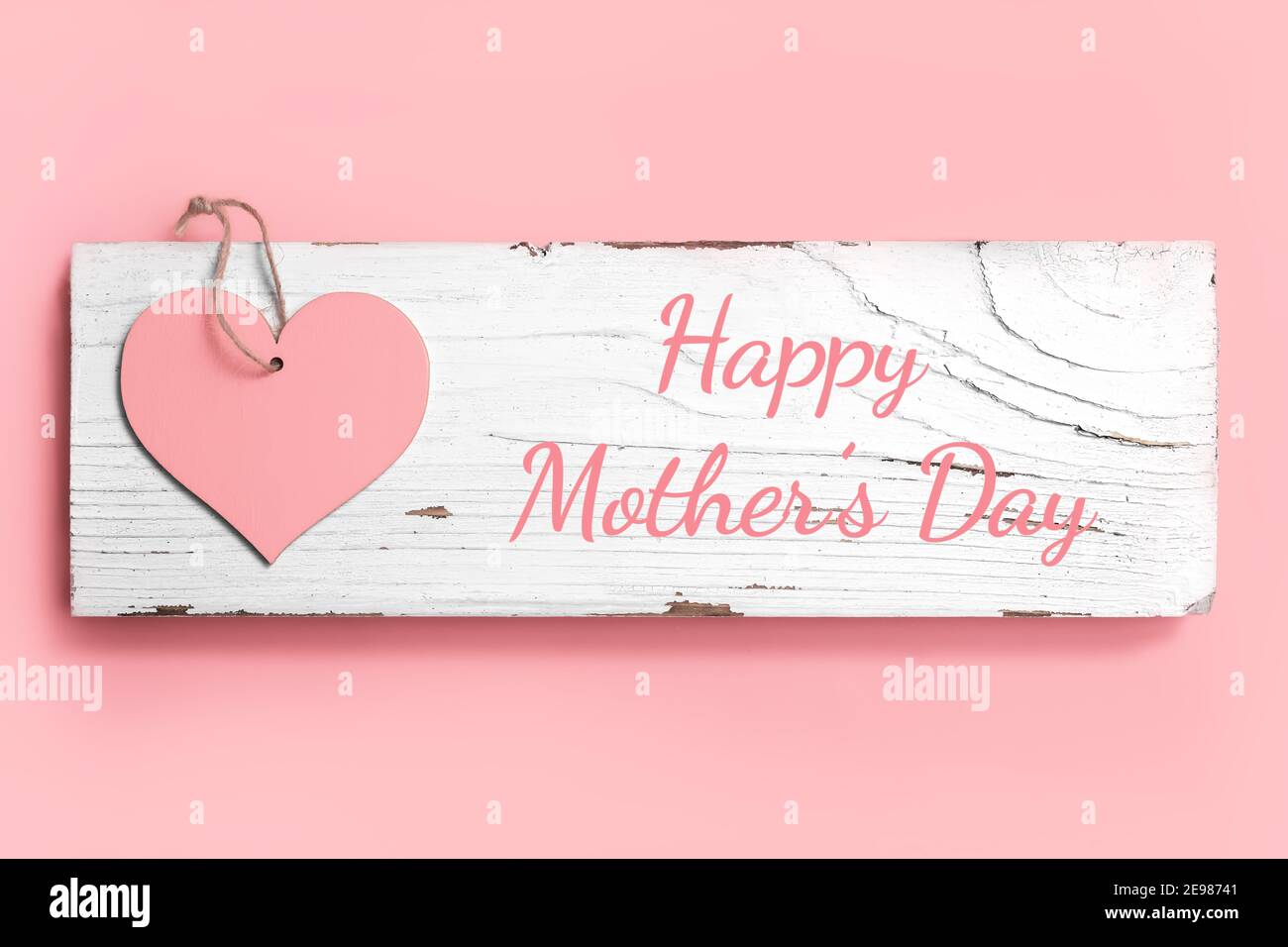 delicate pink heart on white wooden and pink background with text Happy ...
