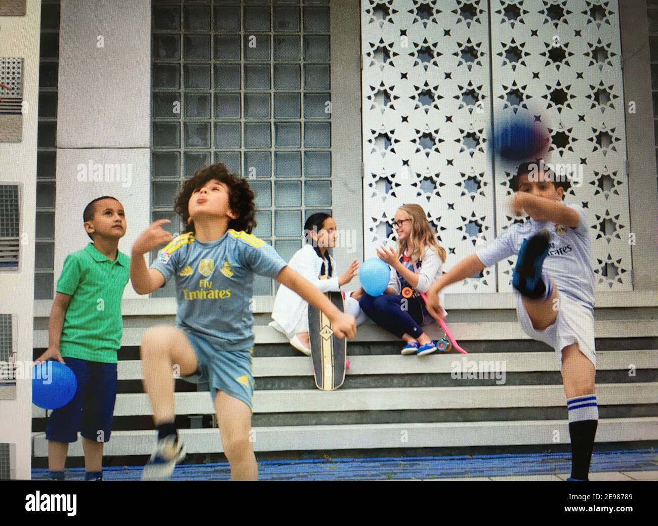 Mosque, children play, football, street photography Stock Photo - Alamy
