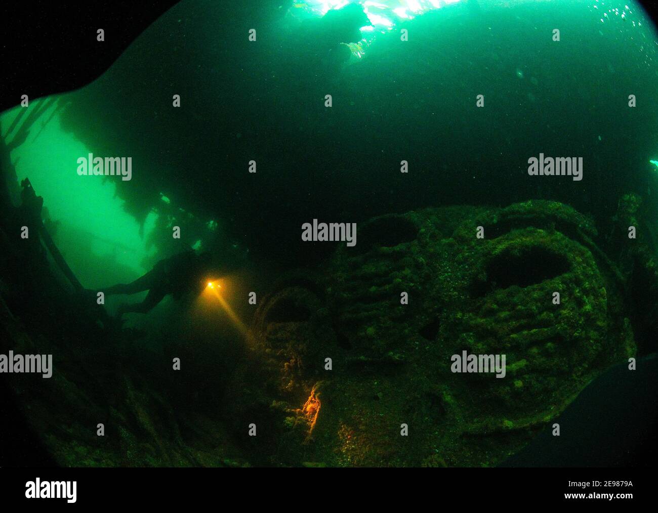 A diver illuminates the boilers of the block ship Tabarka in Burra ...