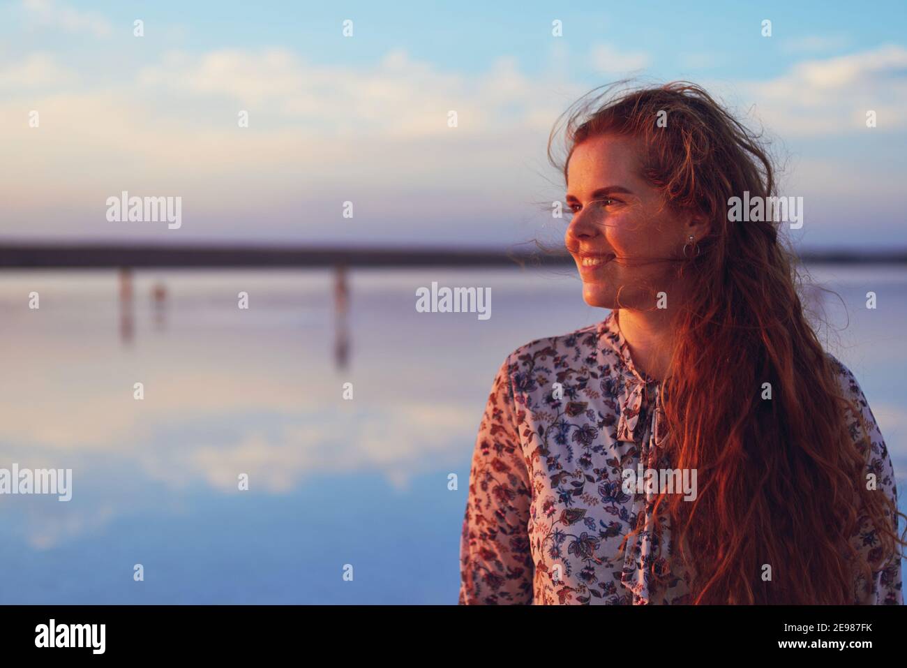 Beautiful young woman with flying red hair on the ocean coast Stock ...